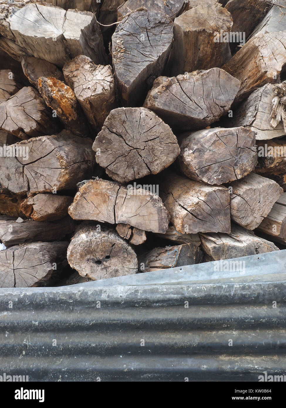 Dry firewood, felled tree trunks, stacked in a woodpile Stock Photo - Alamy