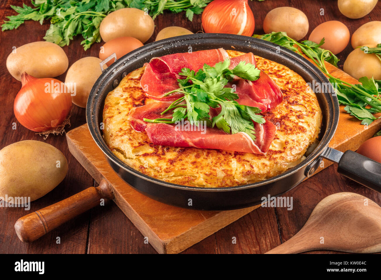 A closeup photo of a Spanish tortilla in a traditional tortillera, with ...