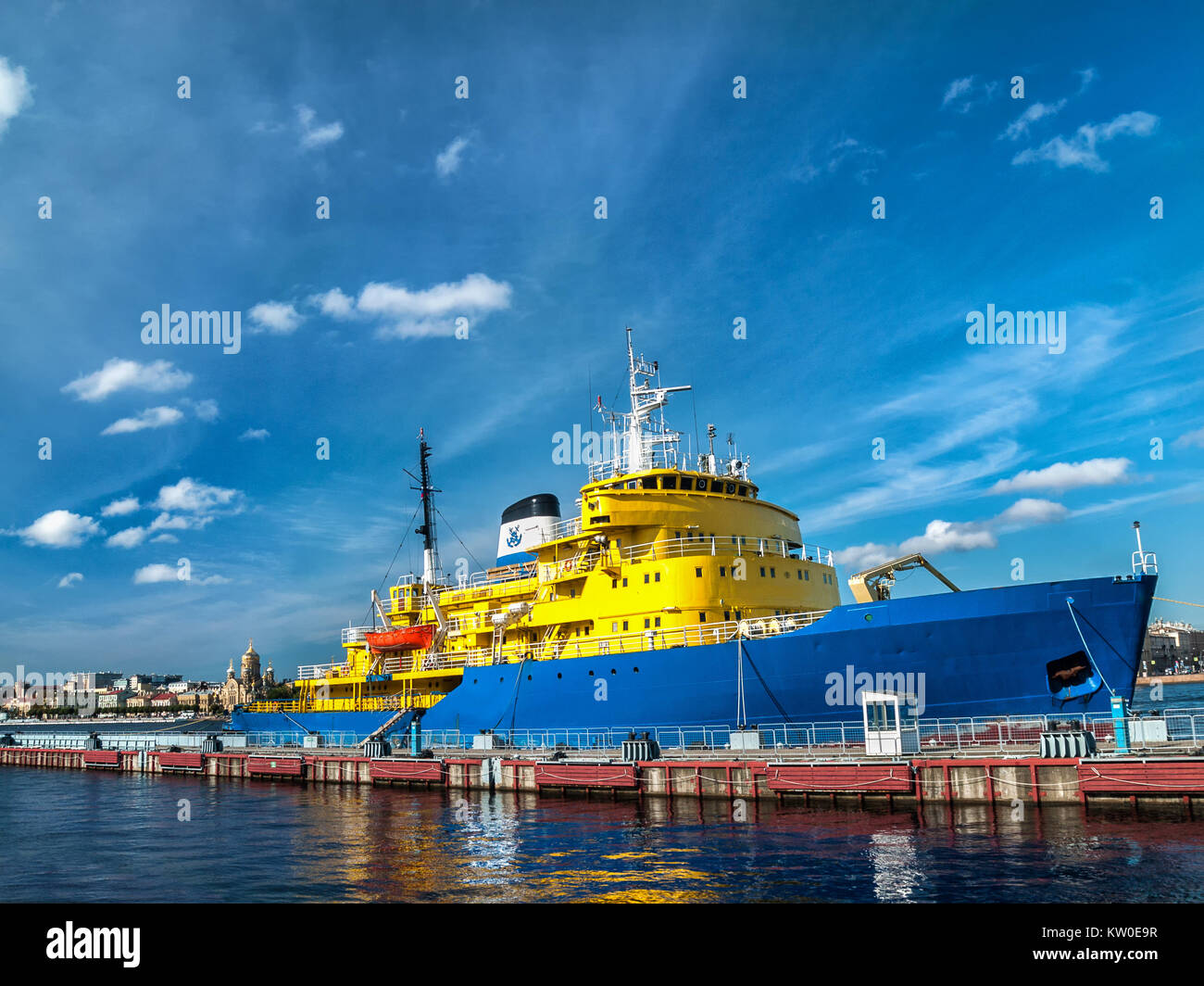 A large diesel ice-breaker of yellow-blue color stands on the ...