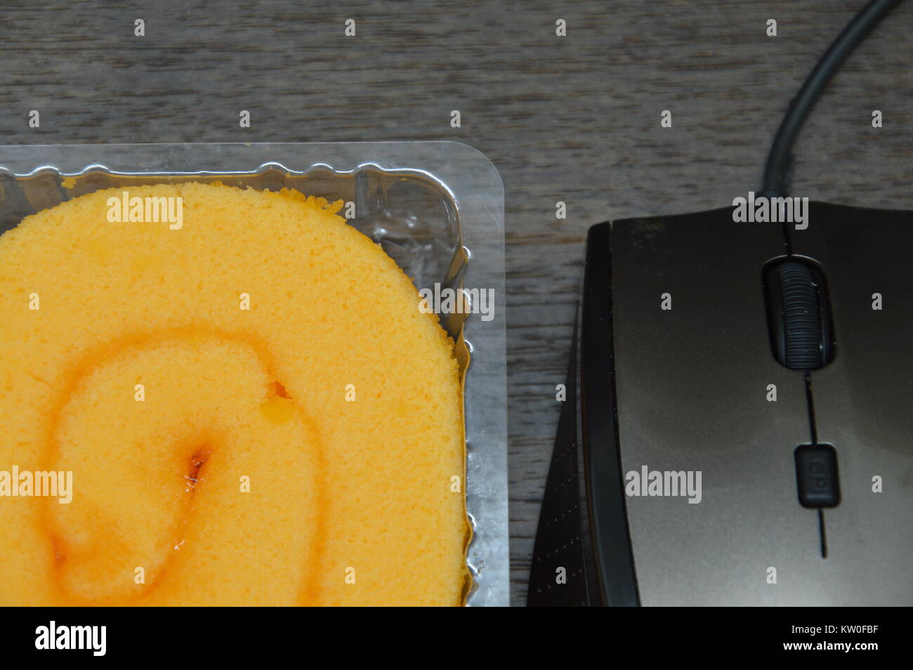 computer mouse and orange cake roll on plastic tray Stock Photo - Alamy