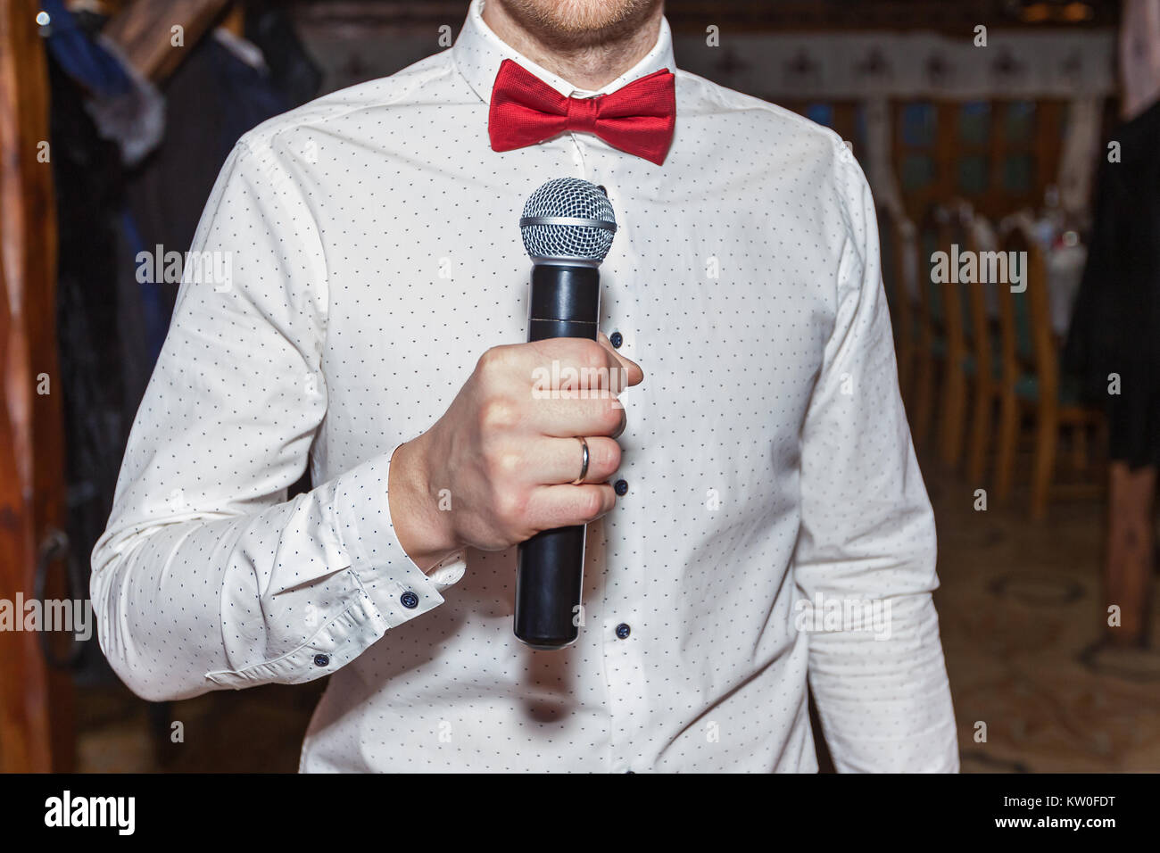 Master of ceremonies in a white shirt and with a red butterfly holding ...