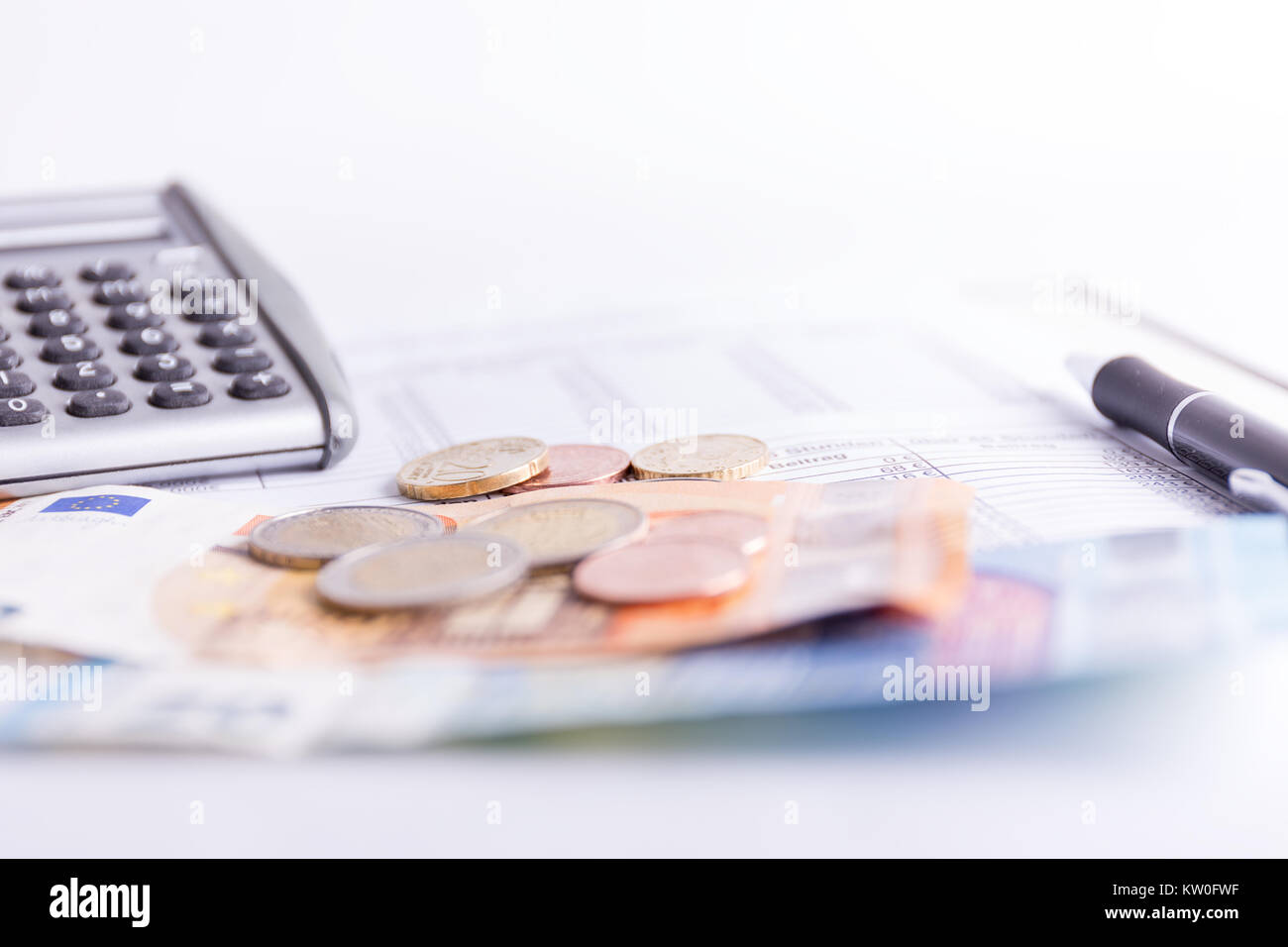 check with calculator and pay the bill with money Stock Photo - Alamy