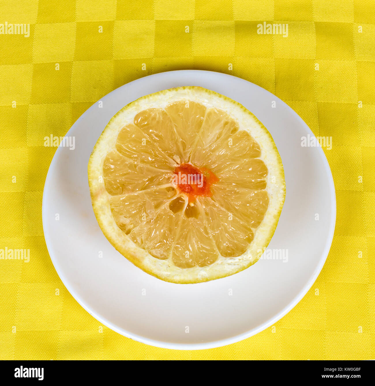 One half of a yellow grapefruit served in a white dish Stock Photo - Alamy
