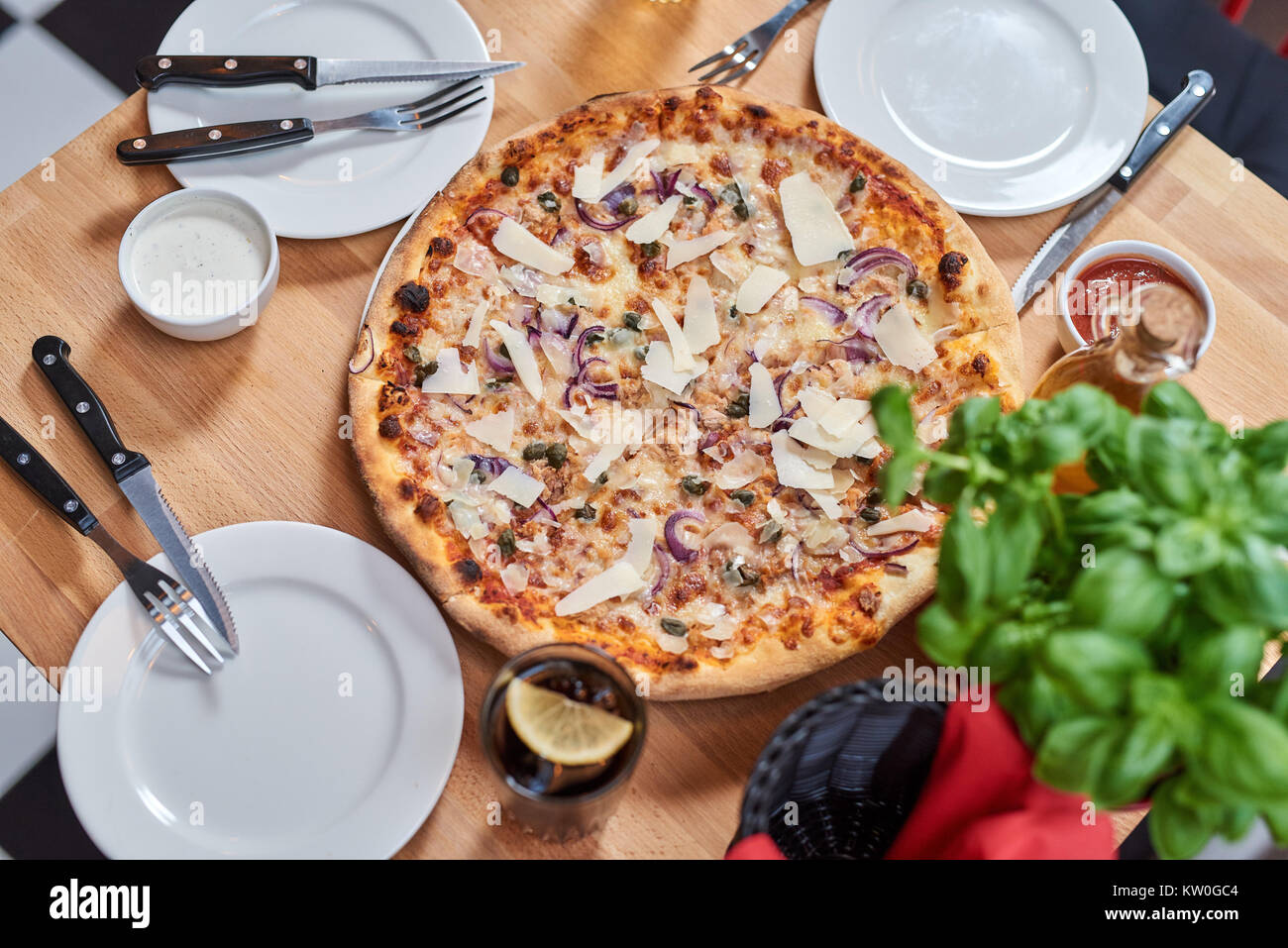 Fresh pizza with on wooden restaurant table Stock Photo - Alamy