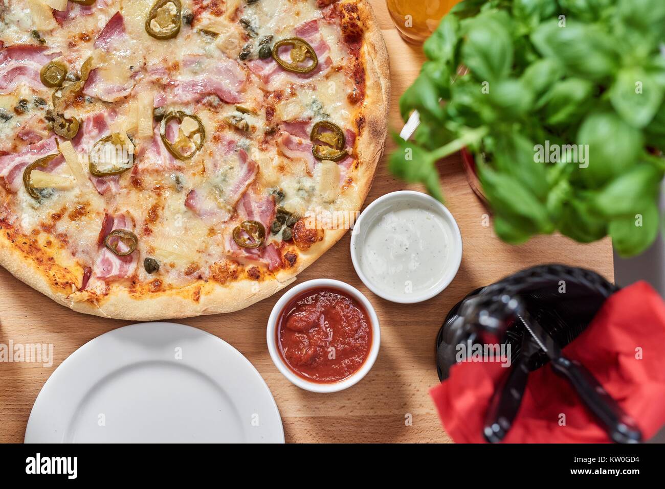 Fresh pizza with on wooden restaurant table Stock Photo - Alamy
