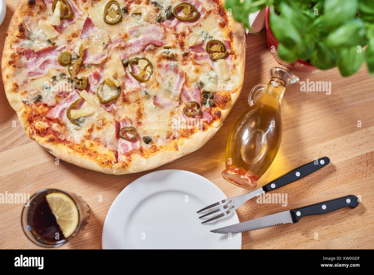 Fresh pizza with on wooden restaurant table Stock Photo - Alamy