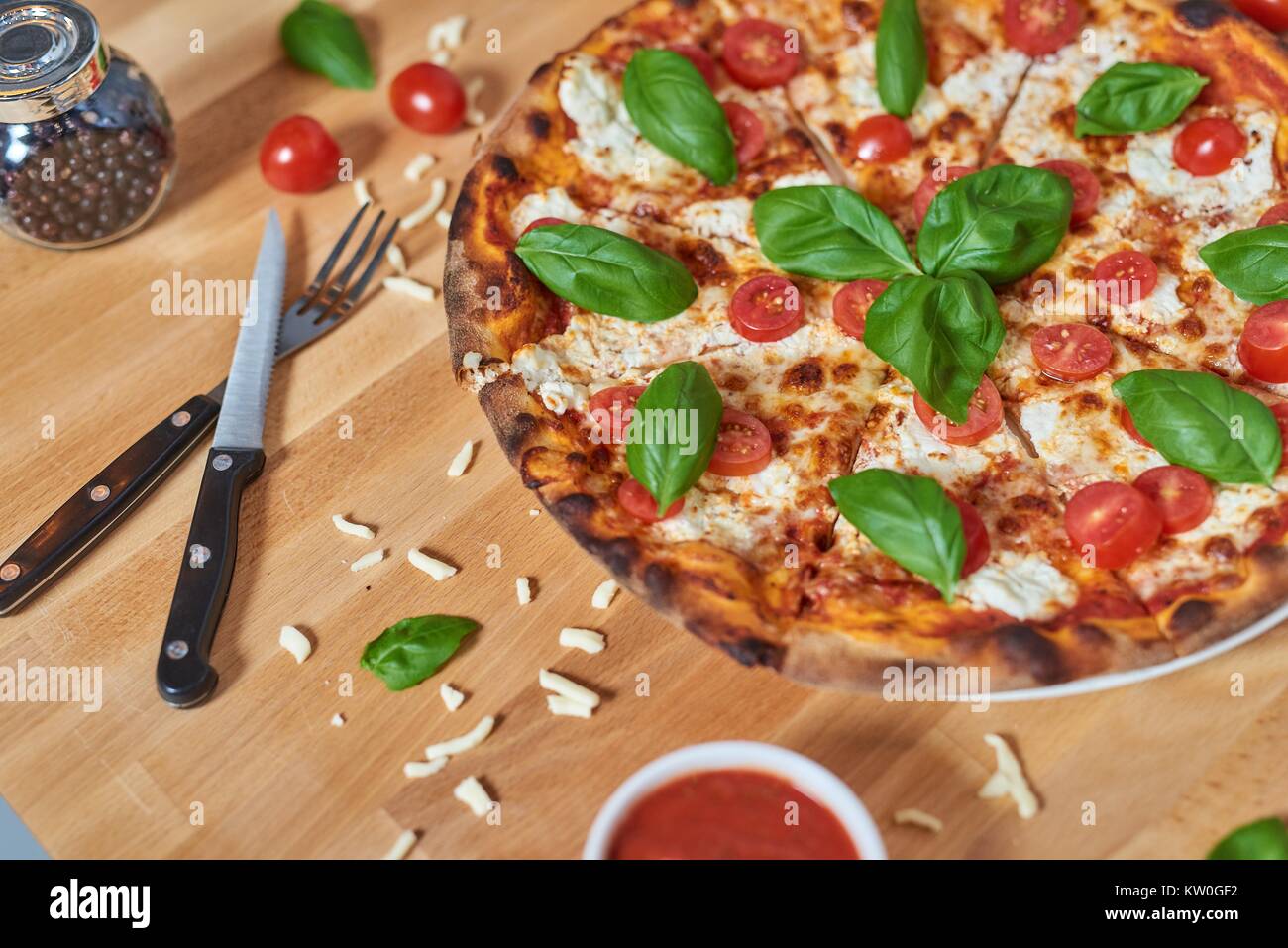 Fresh pizza with on wooden restaurant table Stock Photo - Alamy