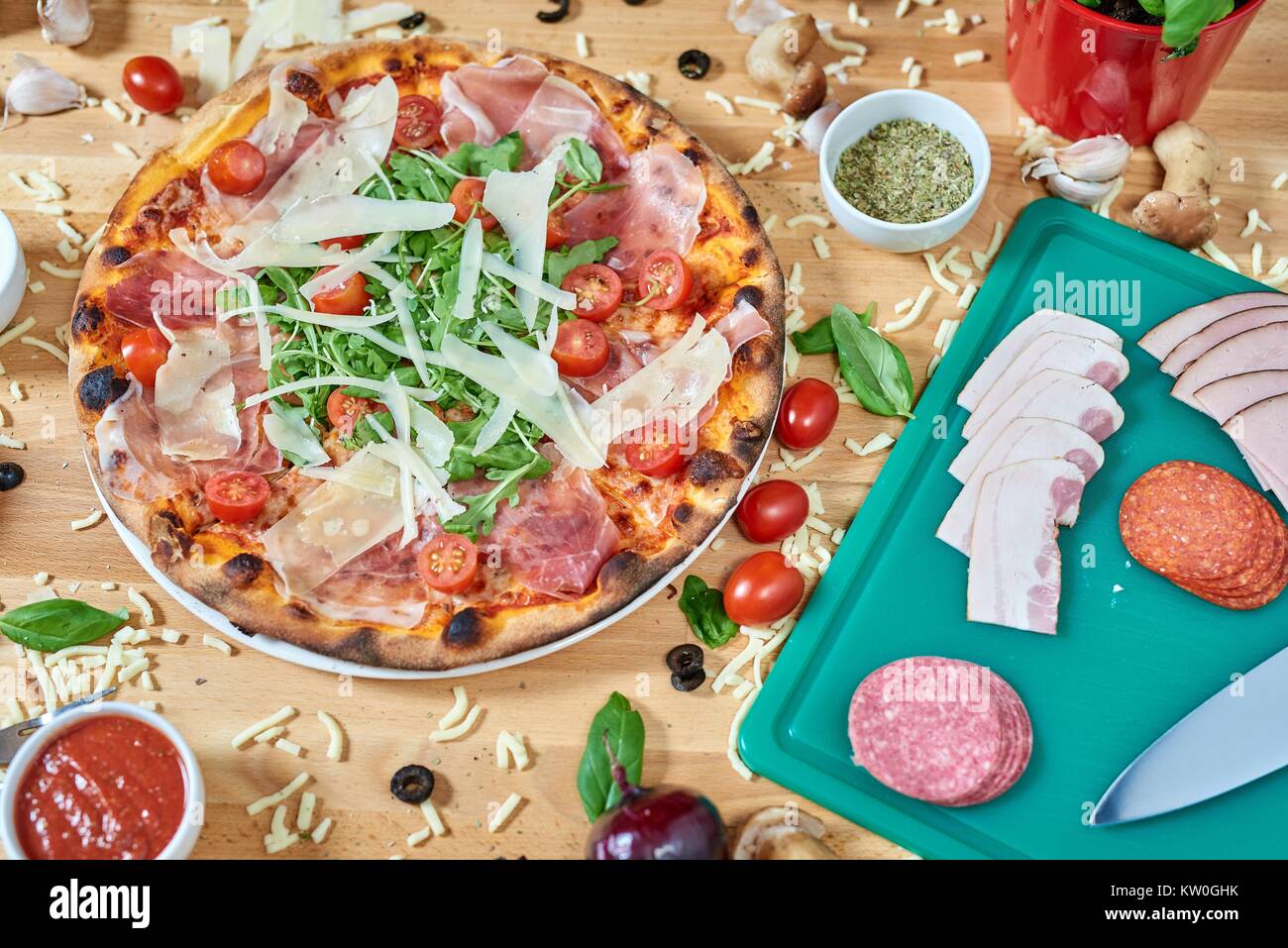 Fresh pizza with on wooden restaurant table Stock Photo - Alamy