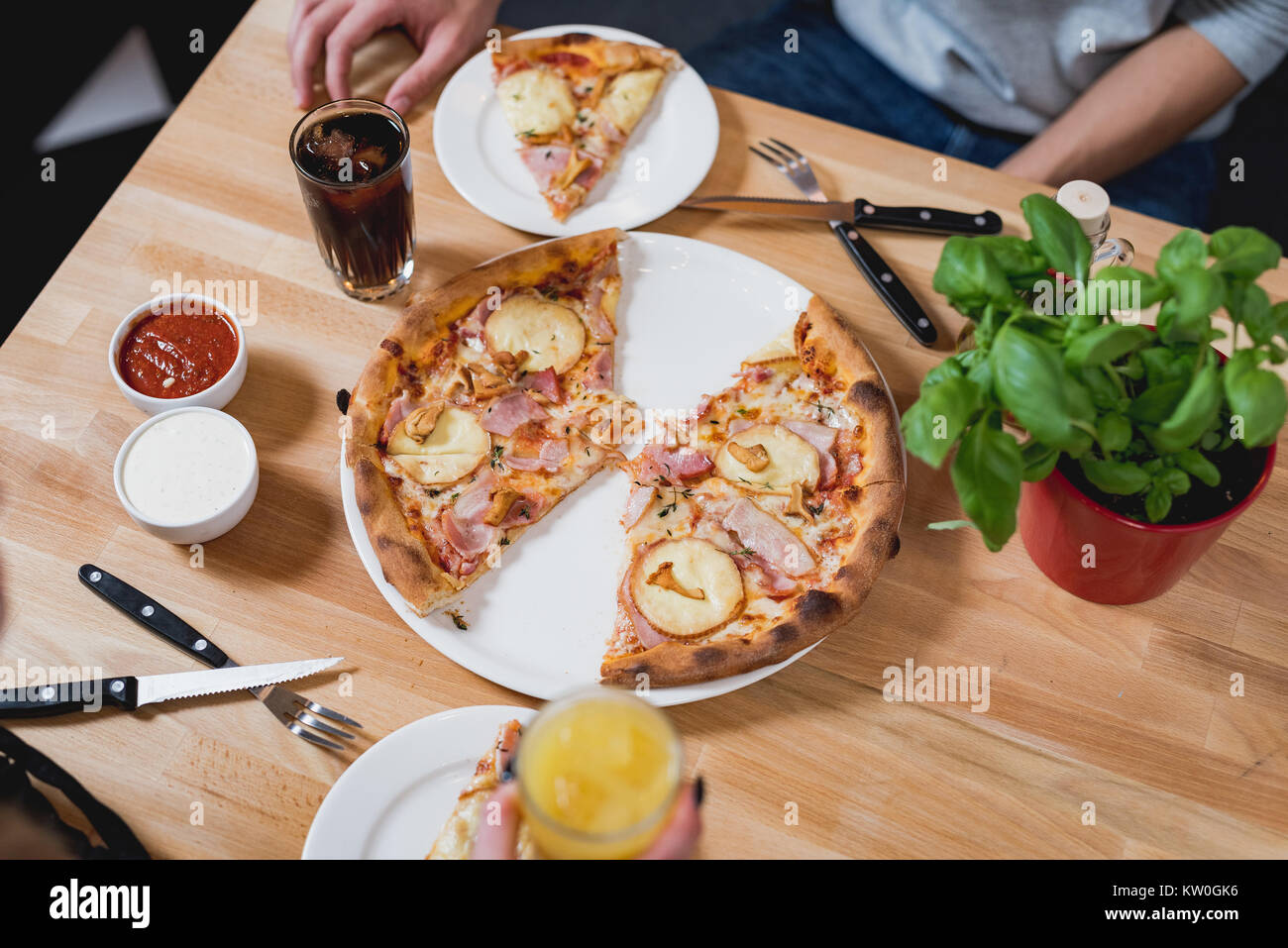 Fresh pizza with on wooden restaurant table Stock Photo - Alamy