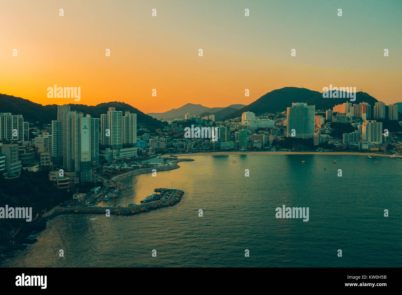Aerial view of Songdo beach and Busan city in sunset from cable car ...