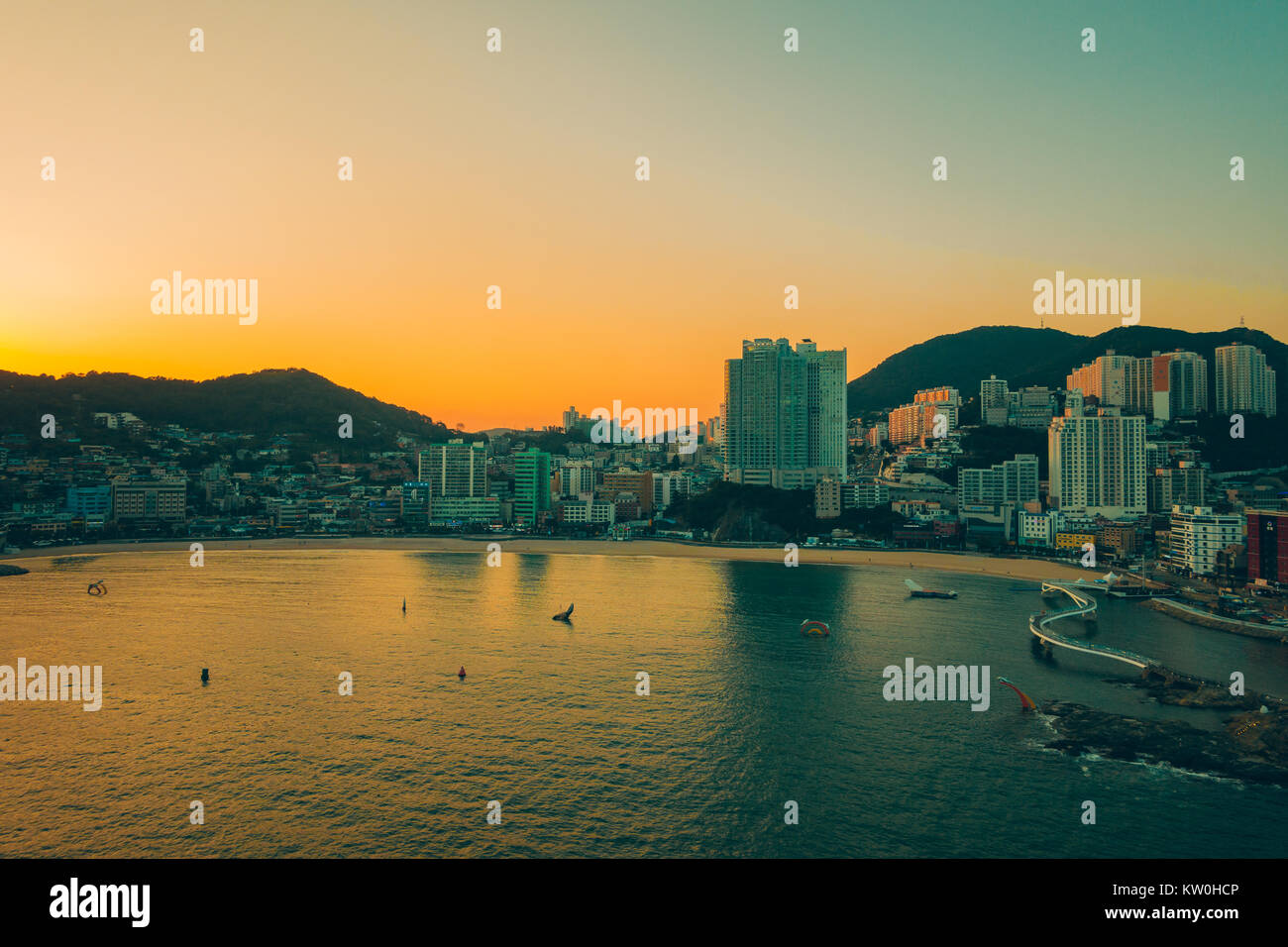 Aerial view of Songdo beach and Busan city in sunset from cable car ...