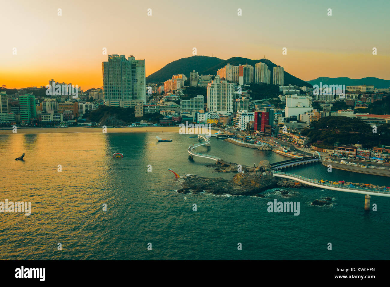 Aerial view of Songdo beach and Busan city in sunset from cable car ...