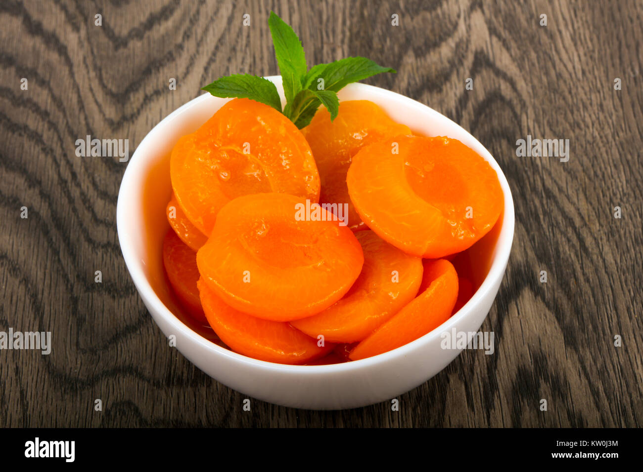 Canned apricots with mint leaves Stock Photo - Alamy