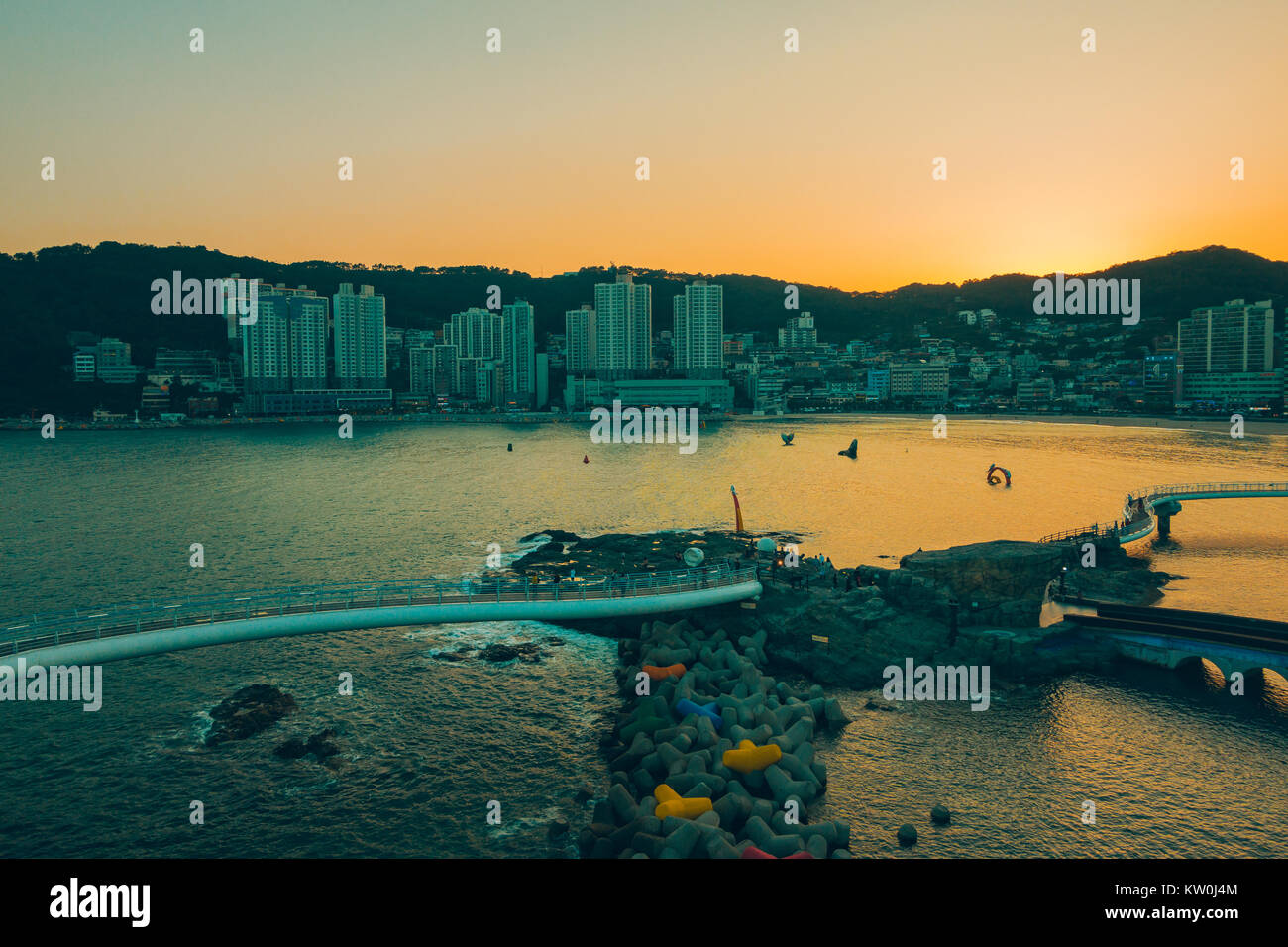 Aerial view of Songdo beach and Busan city in sunset from cable car ...