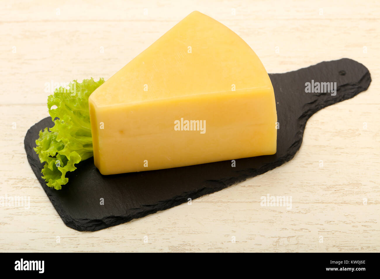 Parmesan cheese triangle Stock Photo - Alamy