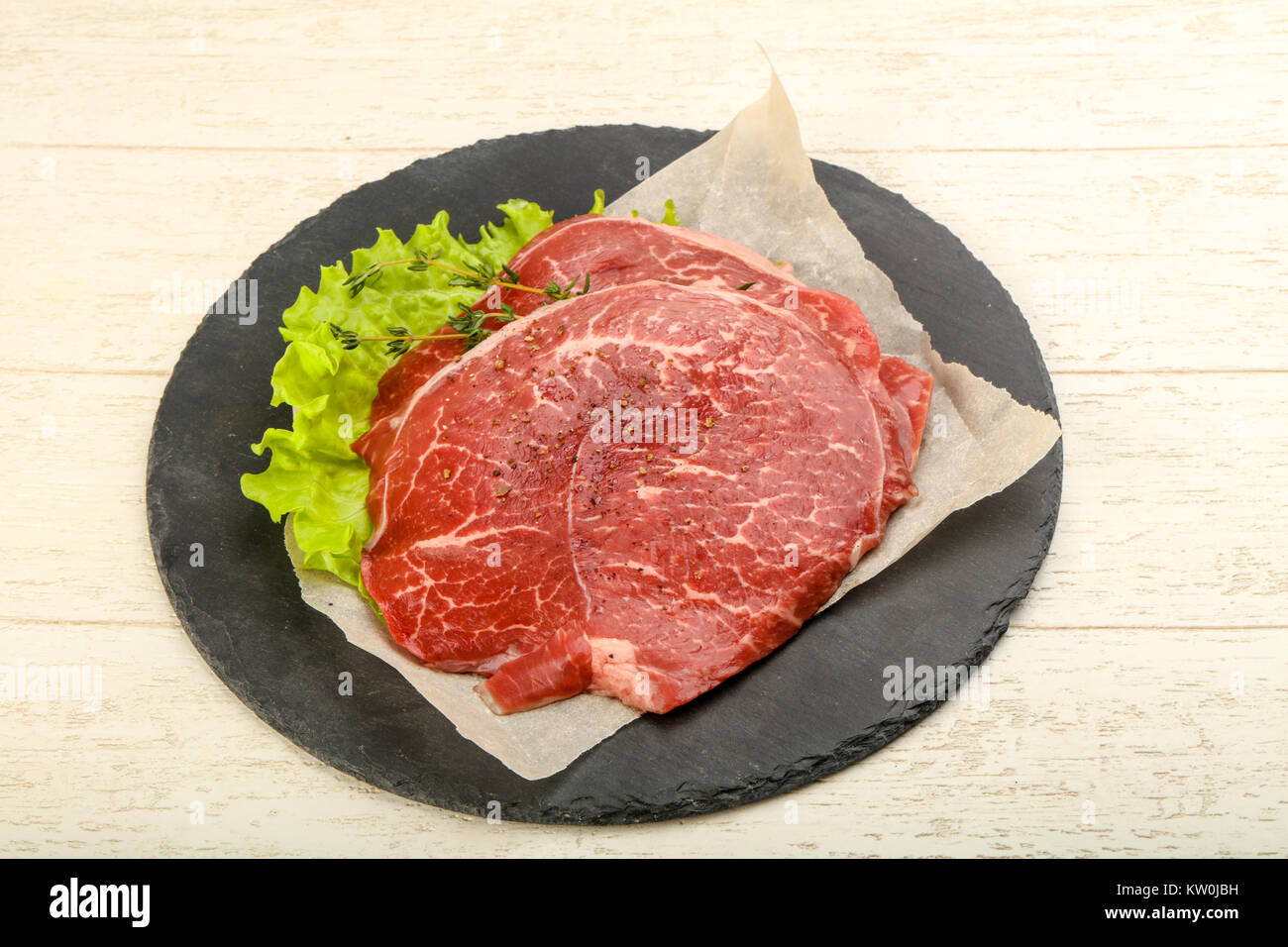 Raw beef schnitzel with spices ready for griil Stock Photo - Alamy
