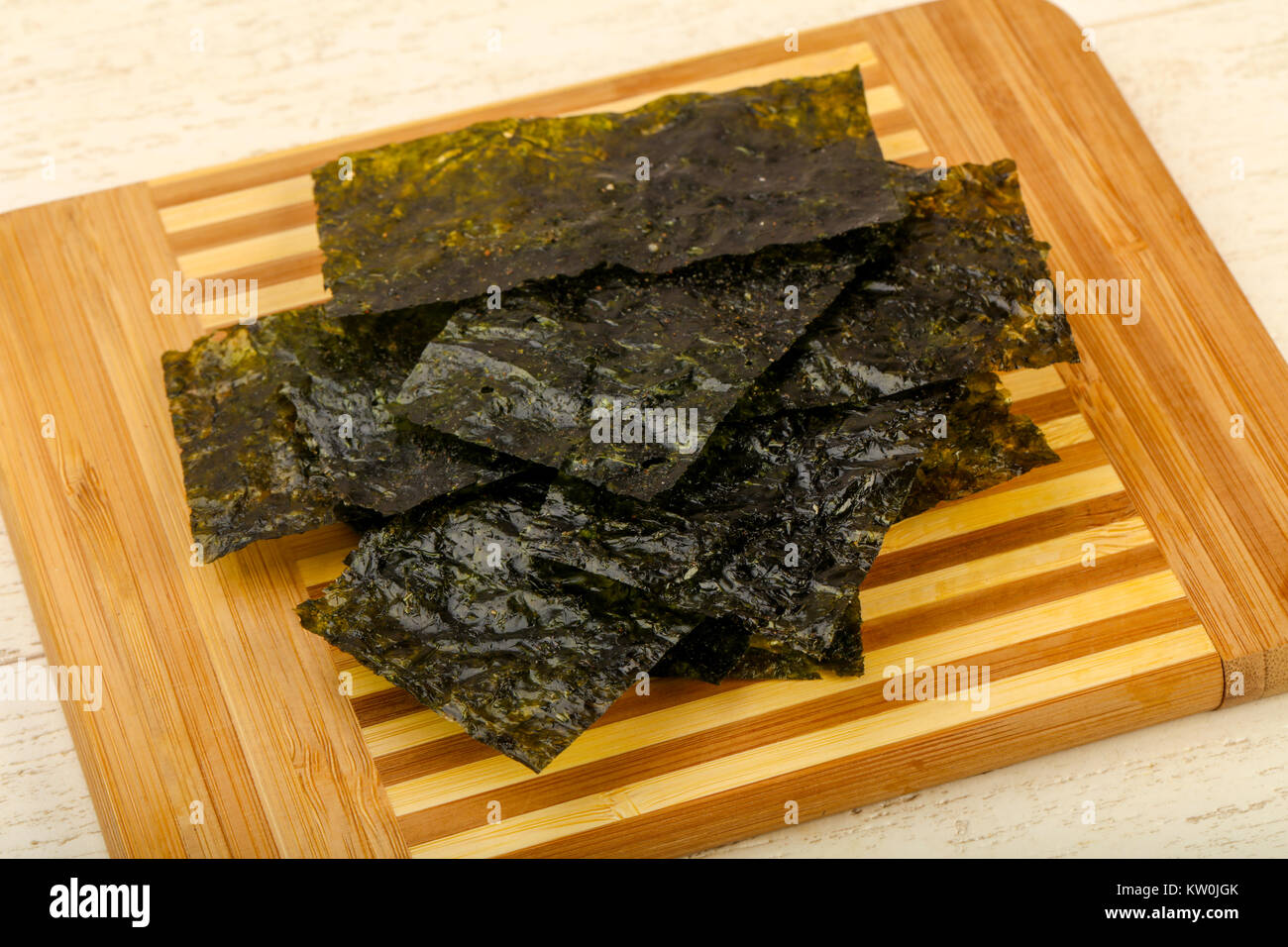 Crispy Nori sheets chips over wooden background Stock Photo - Alamy