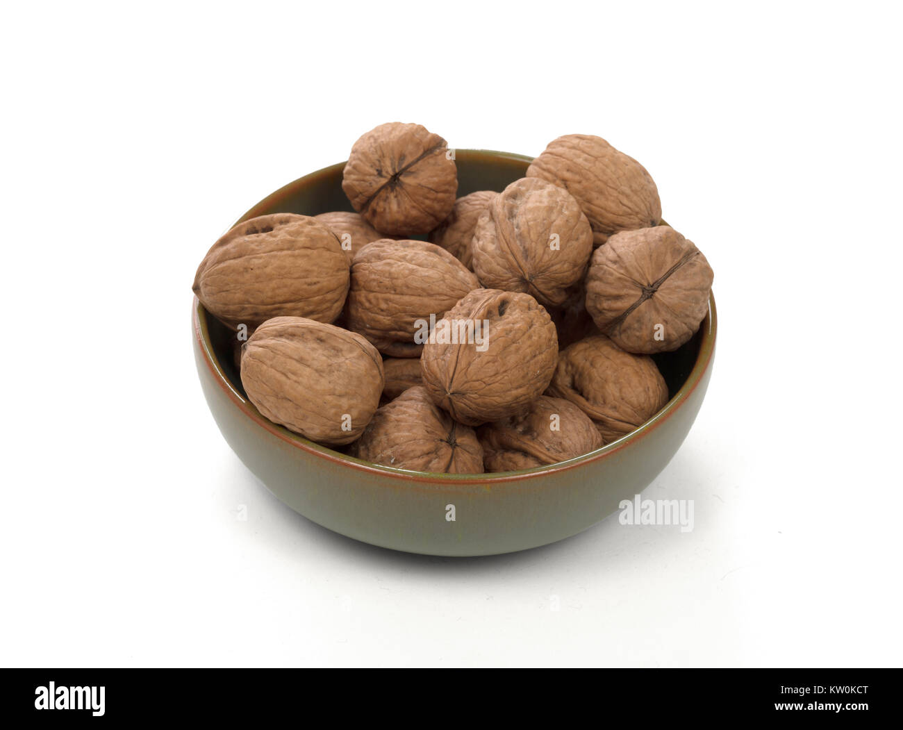Wallnuts in a bowl, isolated on white Stock Photo - Alamy