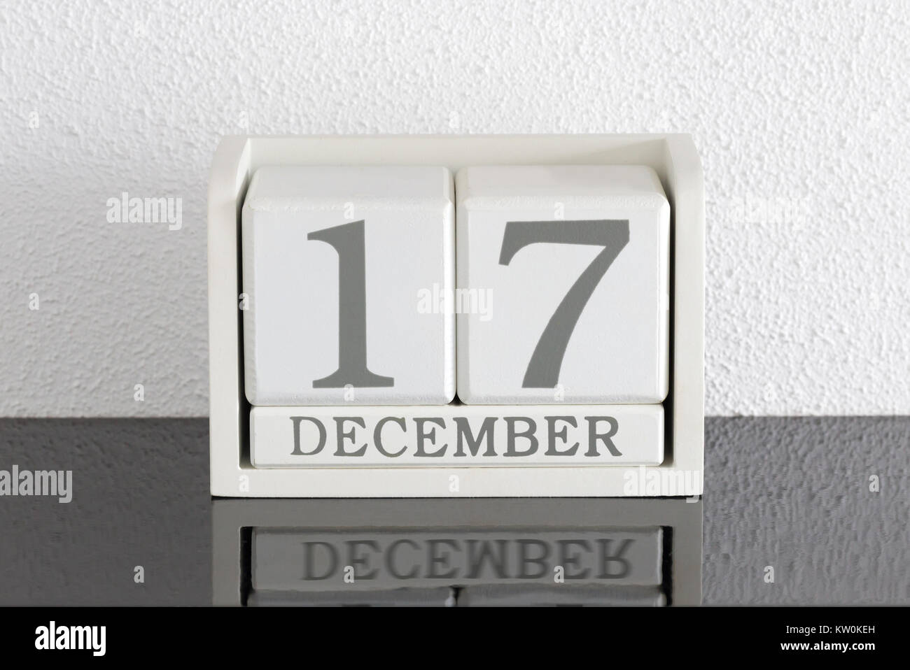 White block calendar present date 17 and month December on white wall ...