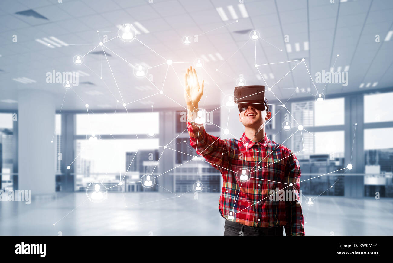 Guy wearing checked shirt and virtual mask reaching hand to touch ...