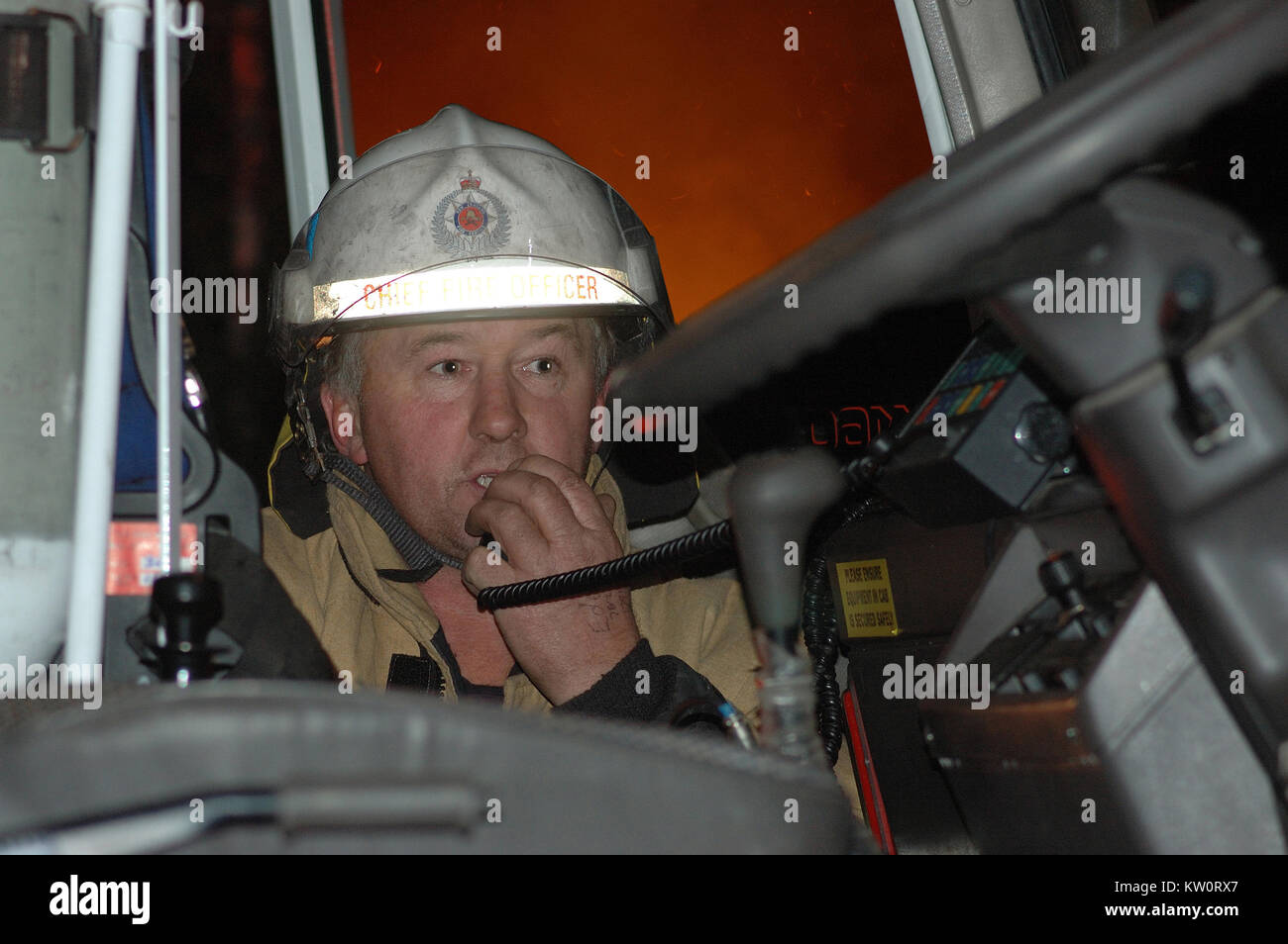 Fire chief calls on radio from fire engine to enlist help in fighting a ...