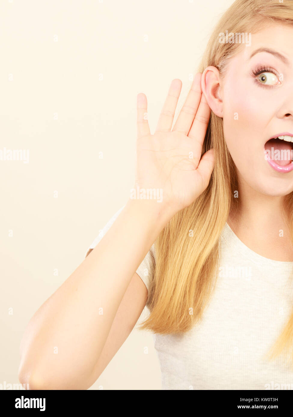 Gossip,rumors, whisper, hearing concept. Young blonde Woman putting ...