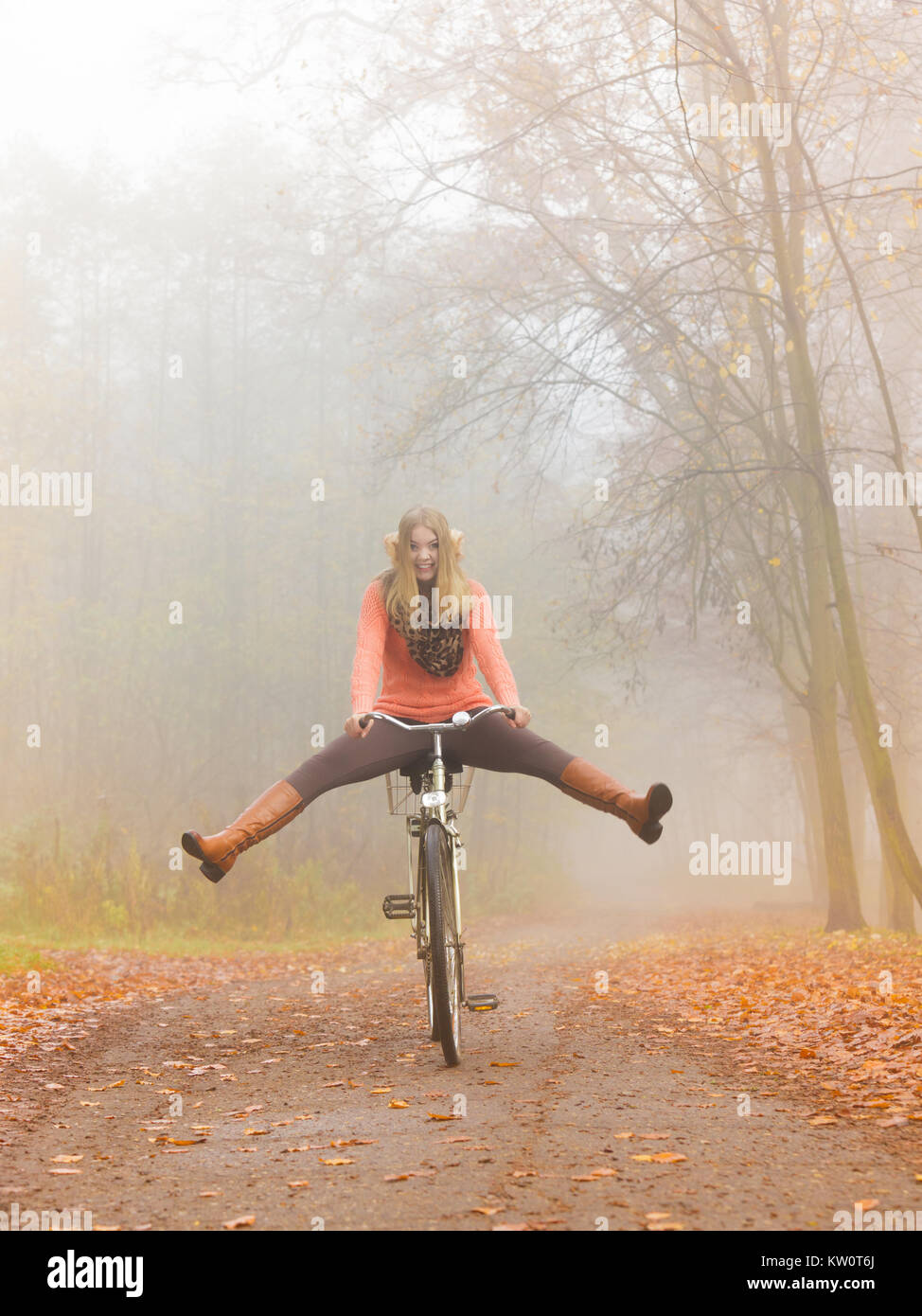 Happy carefree active woman having fun riding bike bicycle in fall ...
