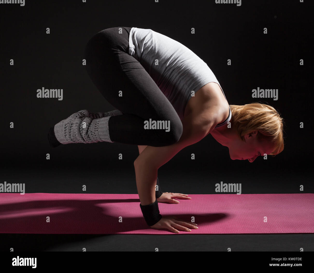 Young woman practicing yoga, Bakasana / Crane pose Stock Photo - Alamy