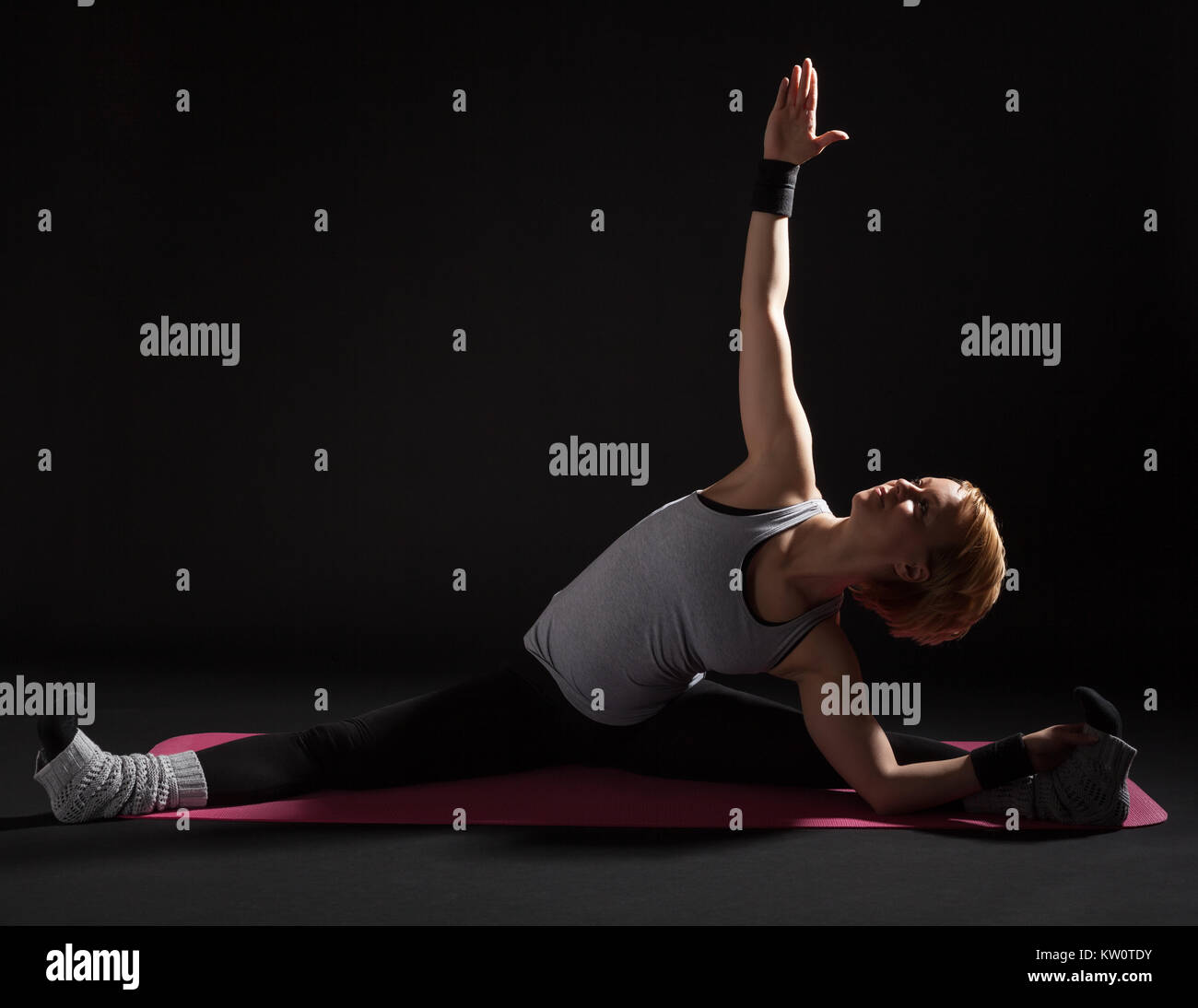 Young woman practicing yoga, Upavistha Konasana / Revolved Seated Angle ...