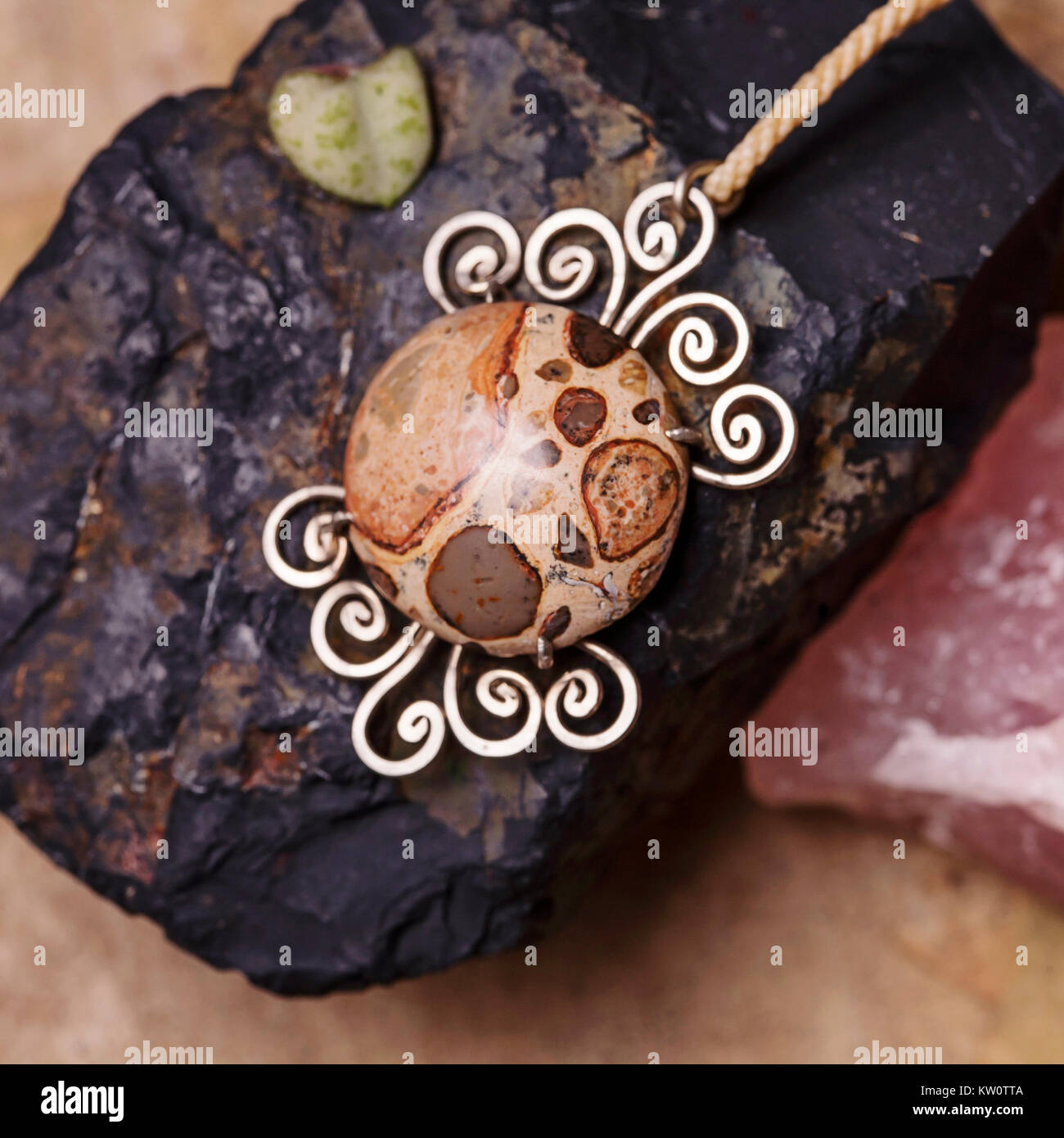 Stone bead necklace pendant on natural background Stock Photo - Alamy