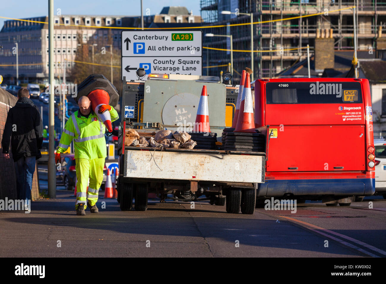 Contruction worker offloading cones on a busy road in Ashford, Kent ...
