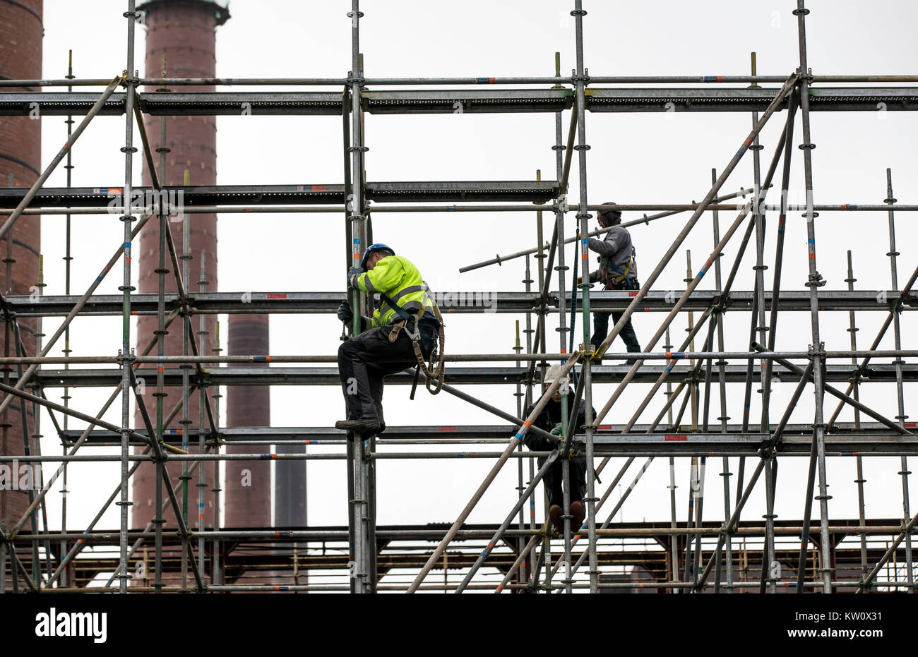 Scaffolders at work, building a large scaffolding, work at high ...