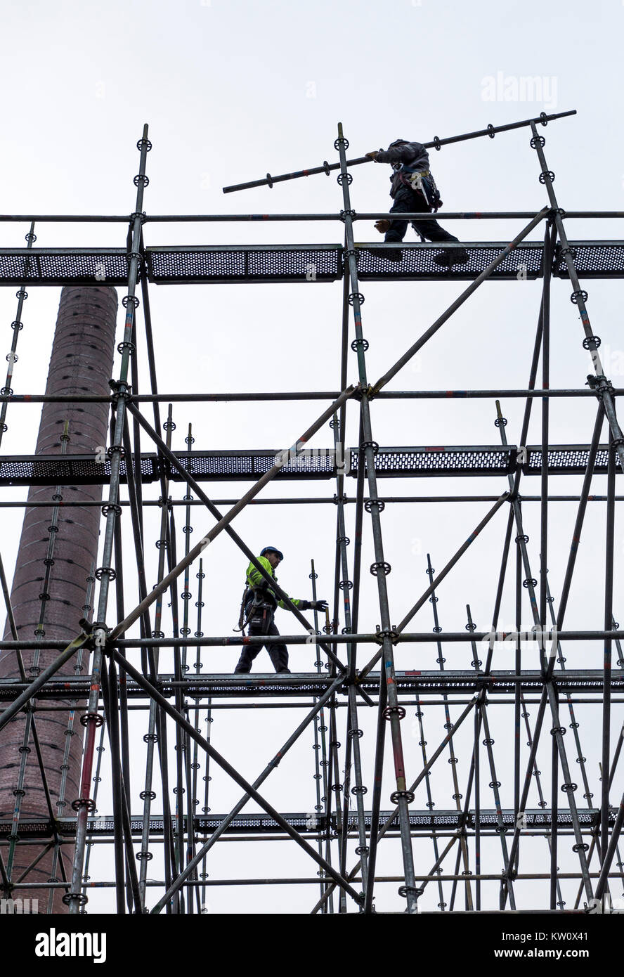 Scaffolders at work, building a large scaffolding, work at high ...