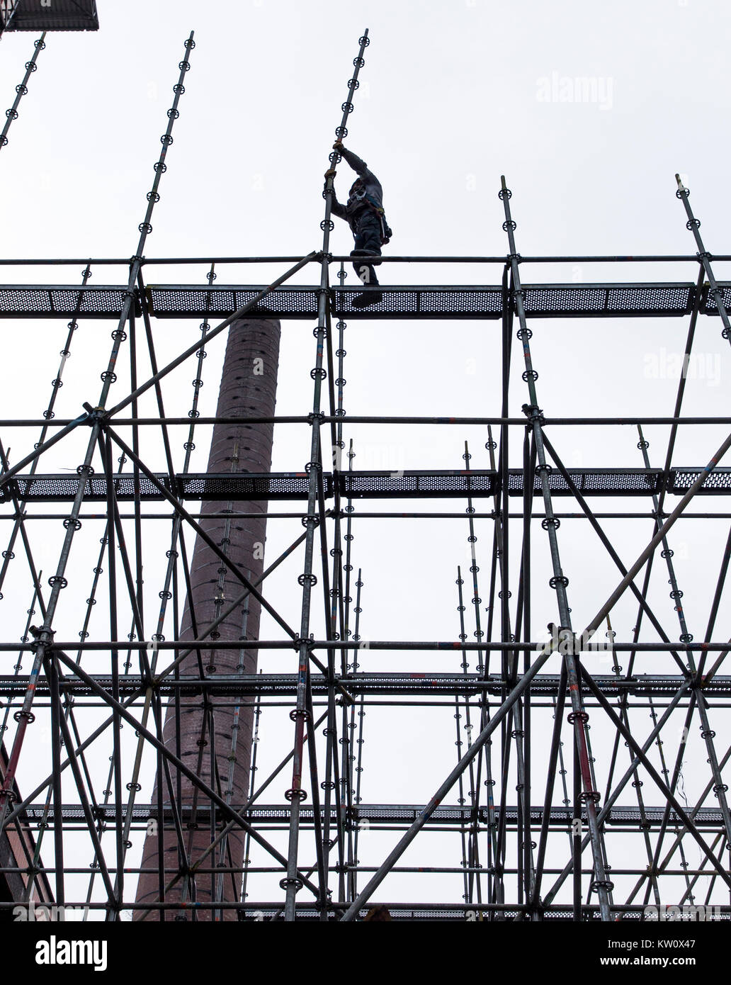 Scaffolders at work, building a large scaffolding, work at high ...
