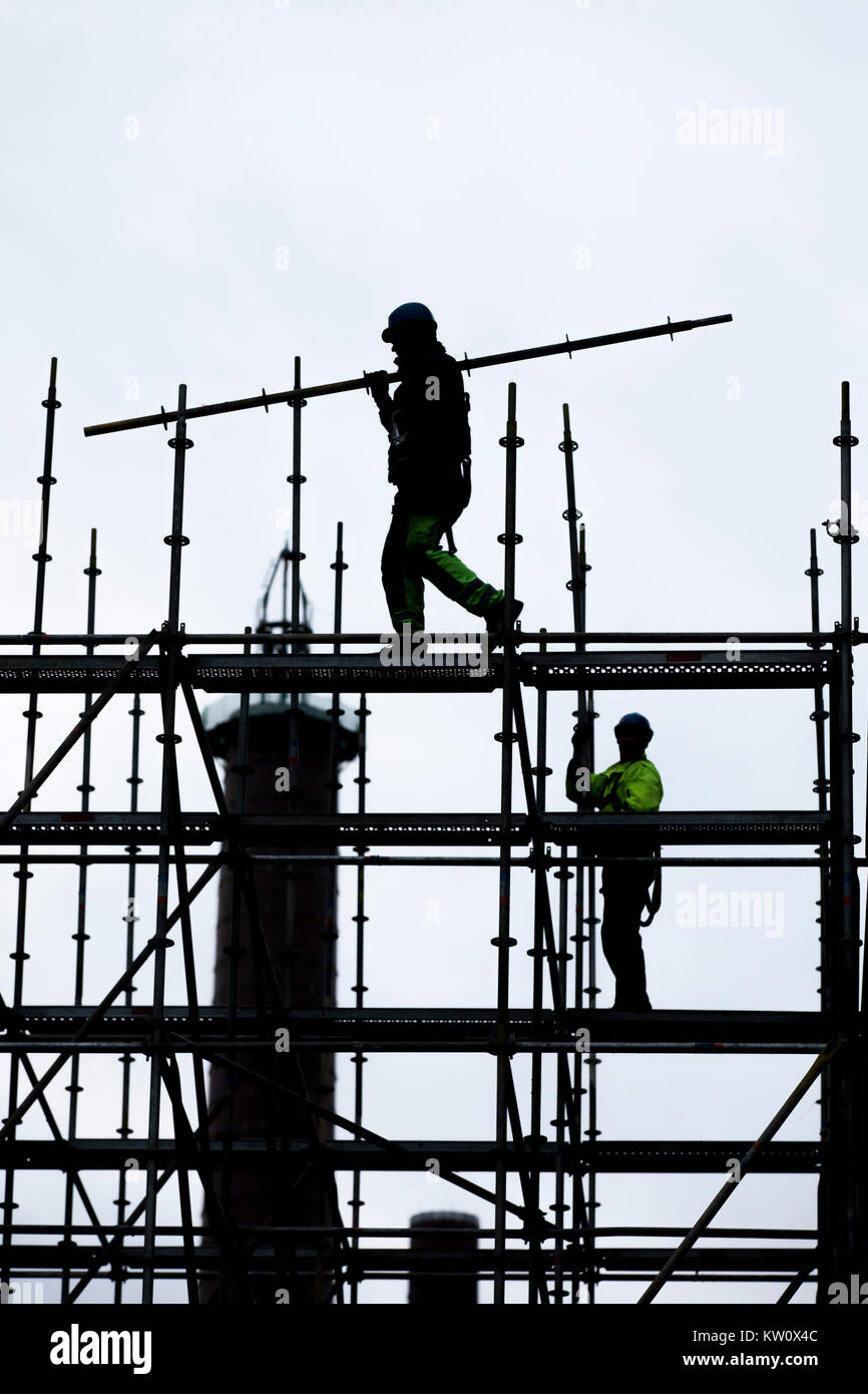 Scaffolders at work, building a large scaffolding, work at high ...