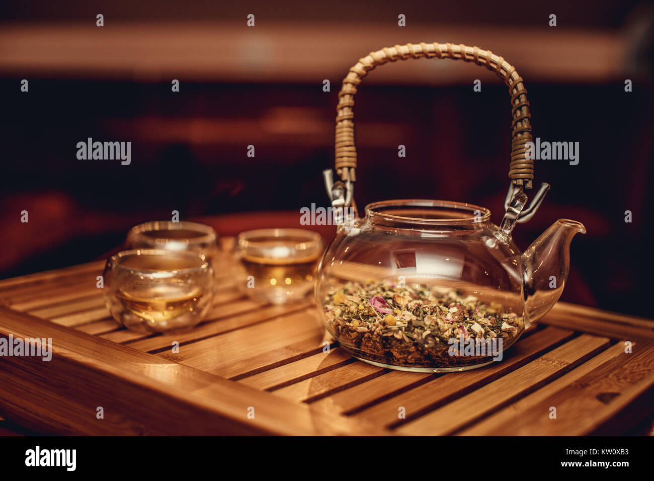 Glass chinese teapot with herbs Stock Photo - Alamy