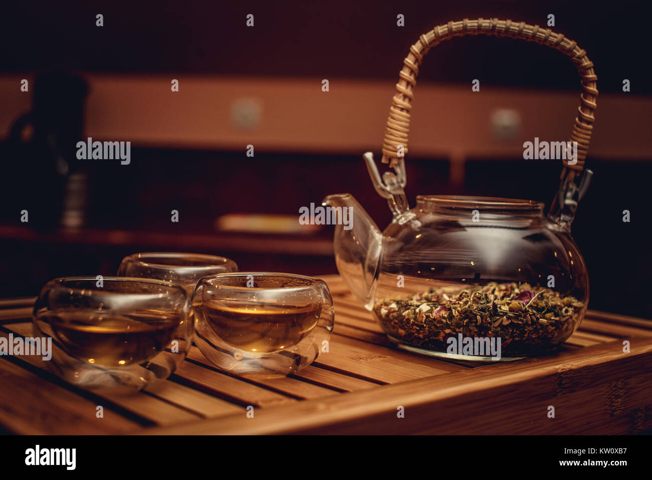 Glass chinese teapot with herbs Stock Photo - Alamy