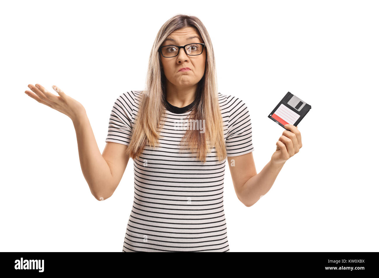 Confused young woman holding a floppy disk isolated on white background ...