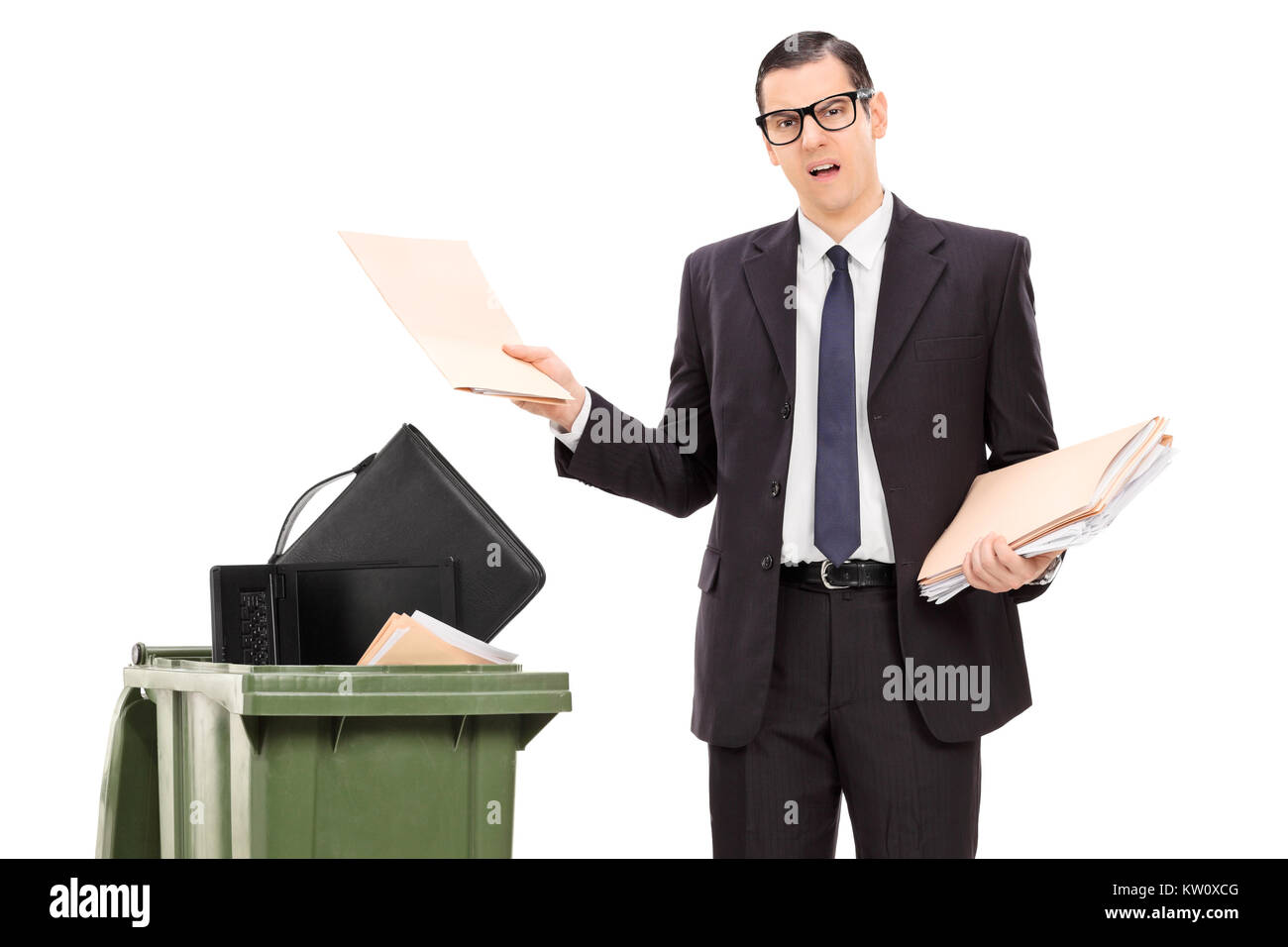 Angry businessman throwing his stuff in a trash can isolated on white ...
