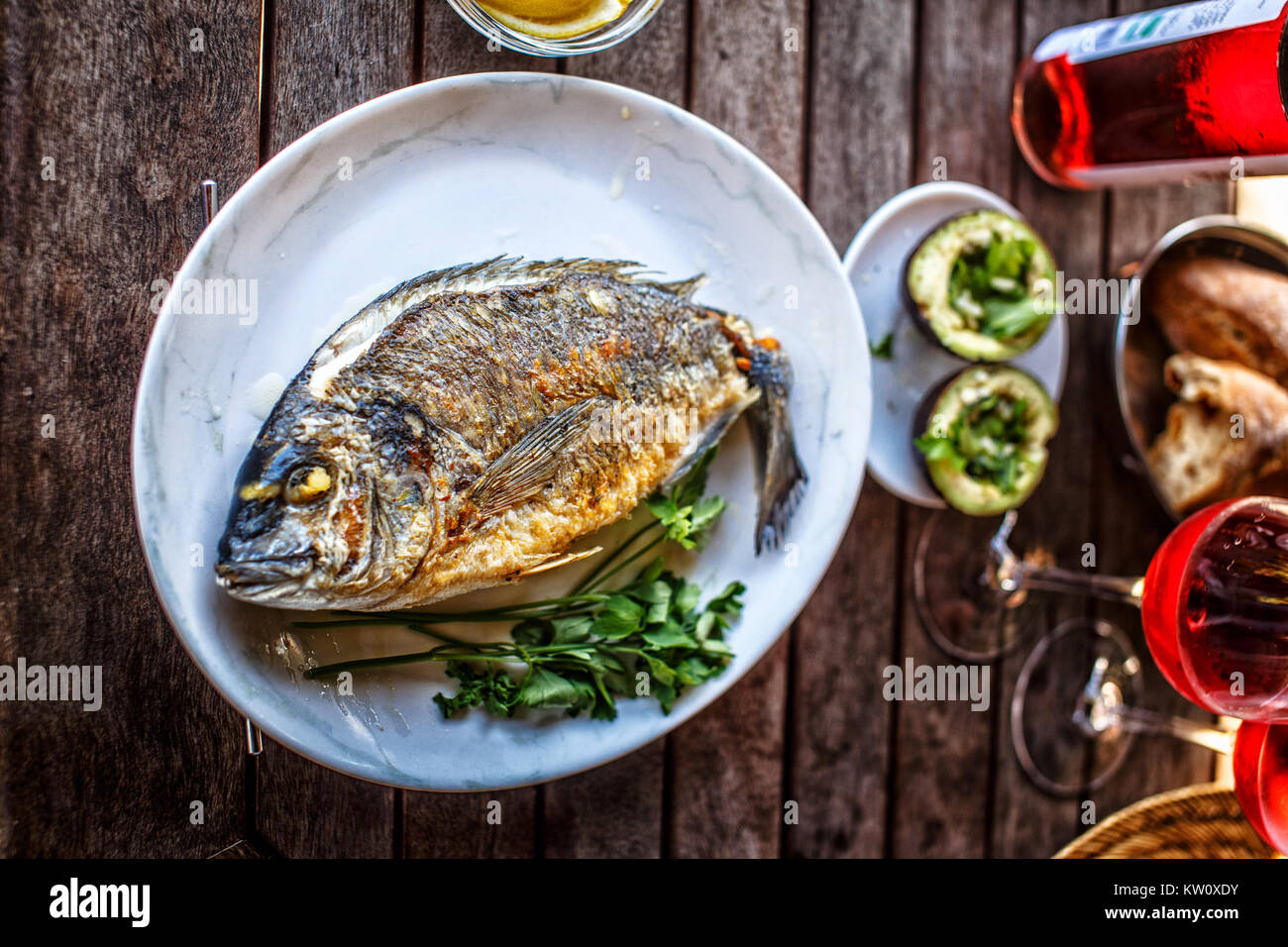 Grilled fish on white plate Stock Photo - Alamy