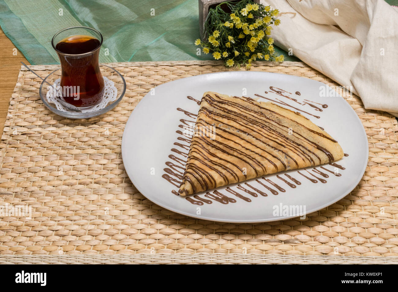 Folded crepe, Russian blini with chocolate sauce on a white plate ...
