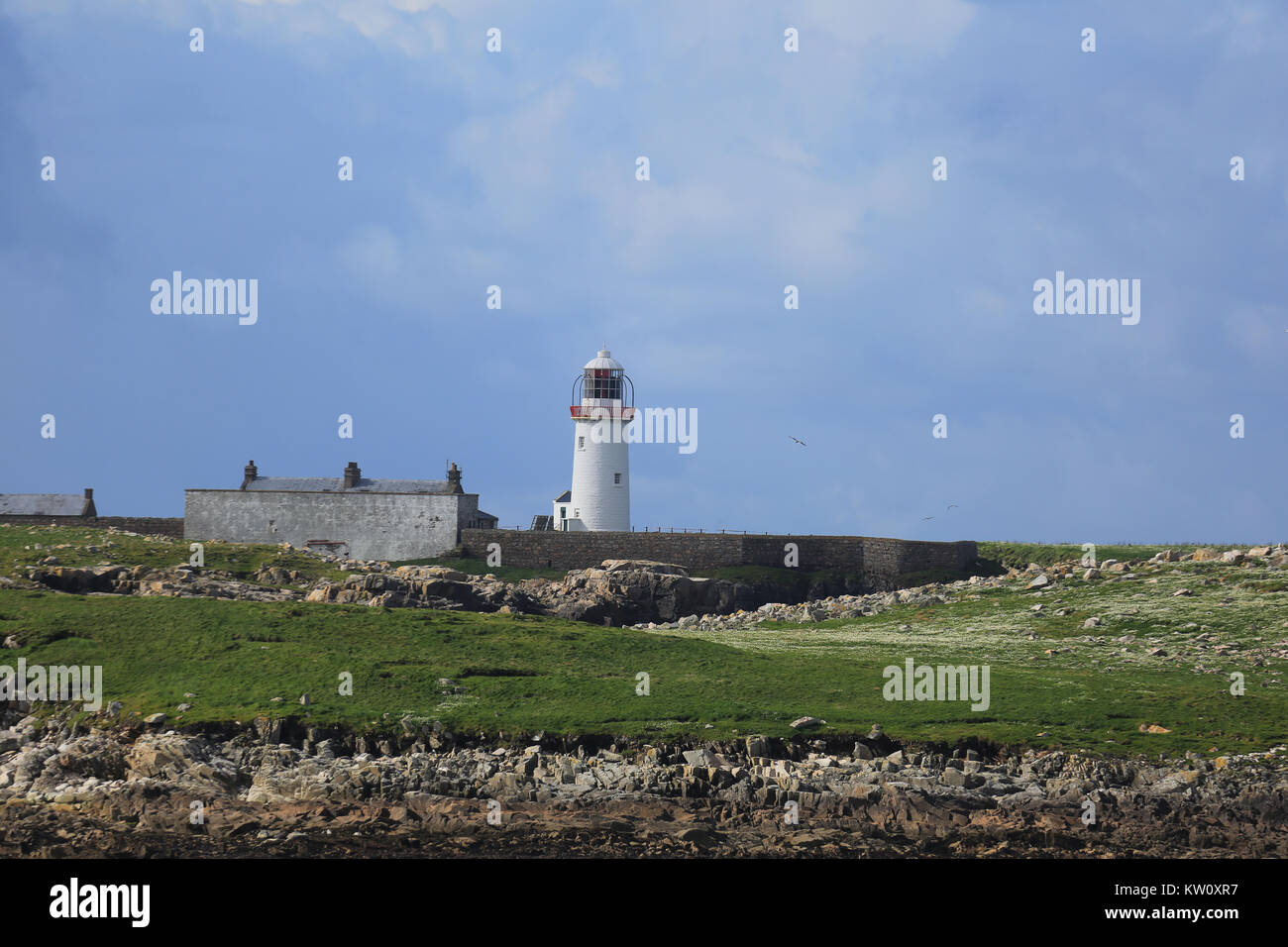 Lighthouse off the coast of Ireland Stock Photo - Alamy