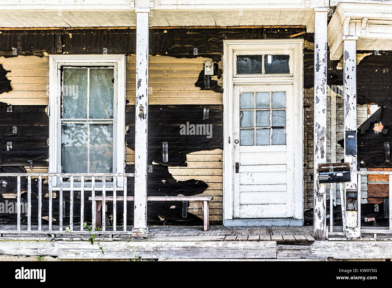 Old abandoned weathered wooden house with porch entrance, peeling paint, dirty windows Stock ...