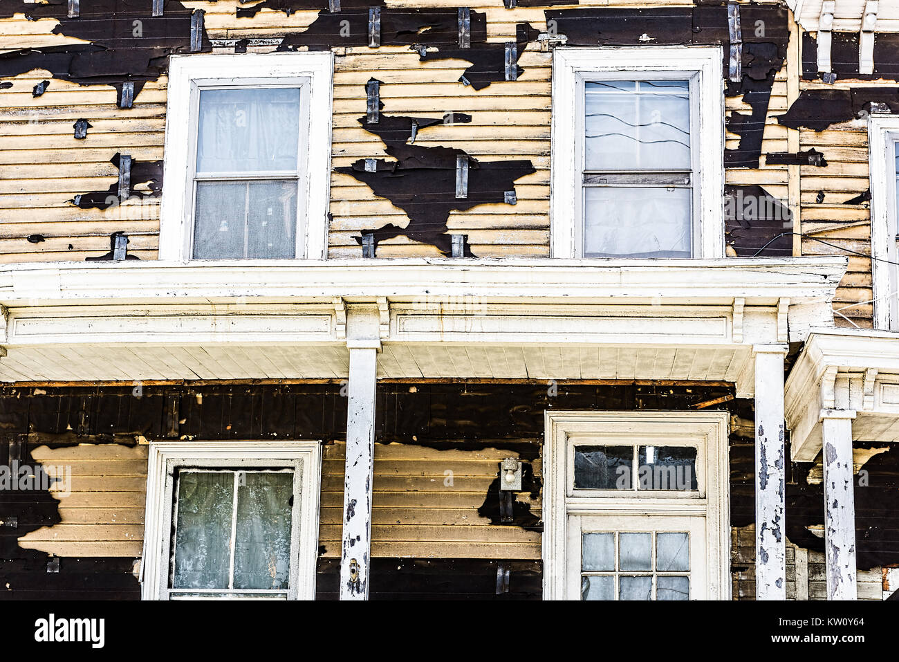 Old abandoned weathered wooden house with porch entrance, peeling paint ...