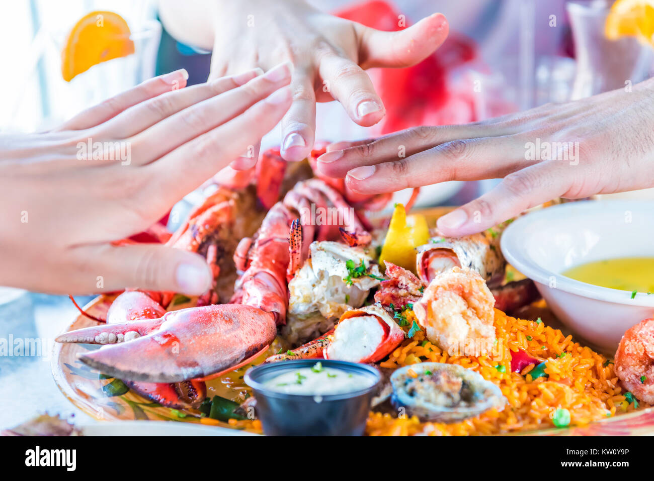 Closeup of whole red lobsters, crab meat, shrimp, rice, and seafood on ...