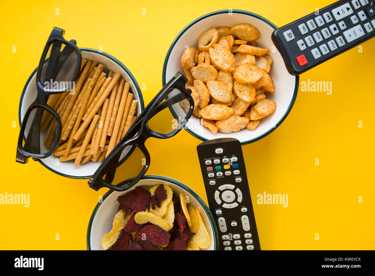 Watching tv shows at home. Three bowls with delicious crunchy snacks ...