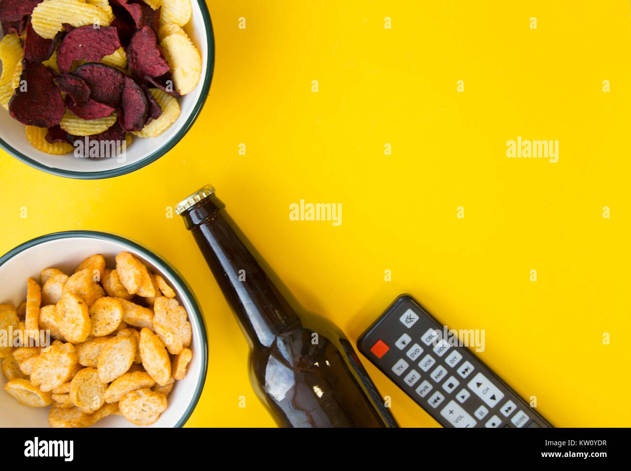 Watching sport channel with friends. Two bowls with crunchy snacks, a ...