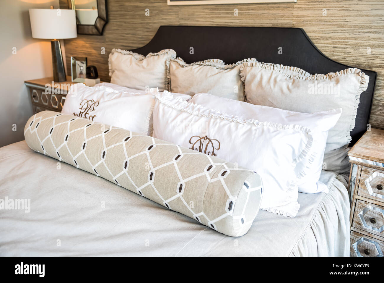 Closeup of new bed comforter with decorative pillows in bedroom in ...