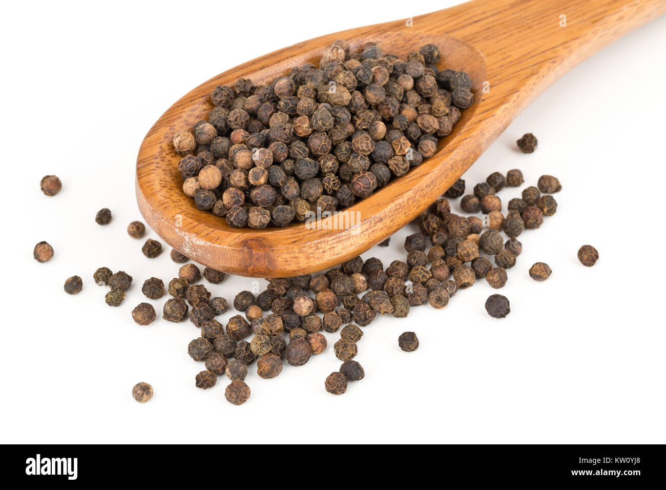 Heap of raw, natural, unprocessed black pepper peppercorns in wooden ...