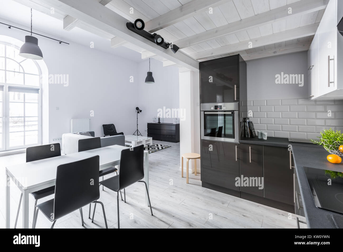Kitchenette and dining space in open plan loft apartment Stock Photo ...